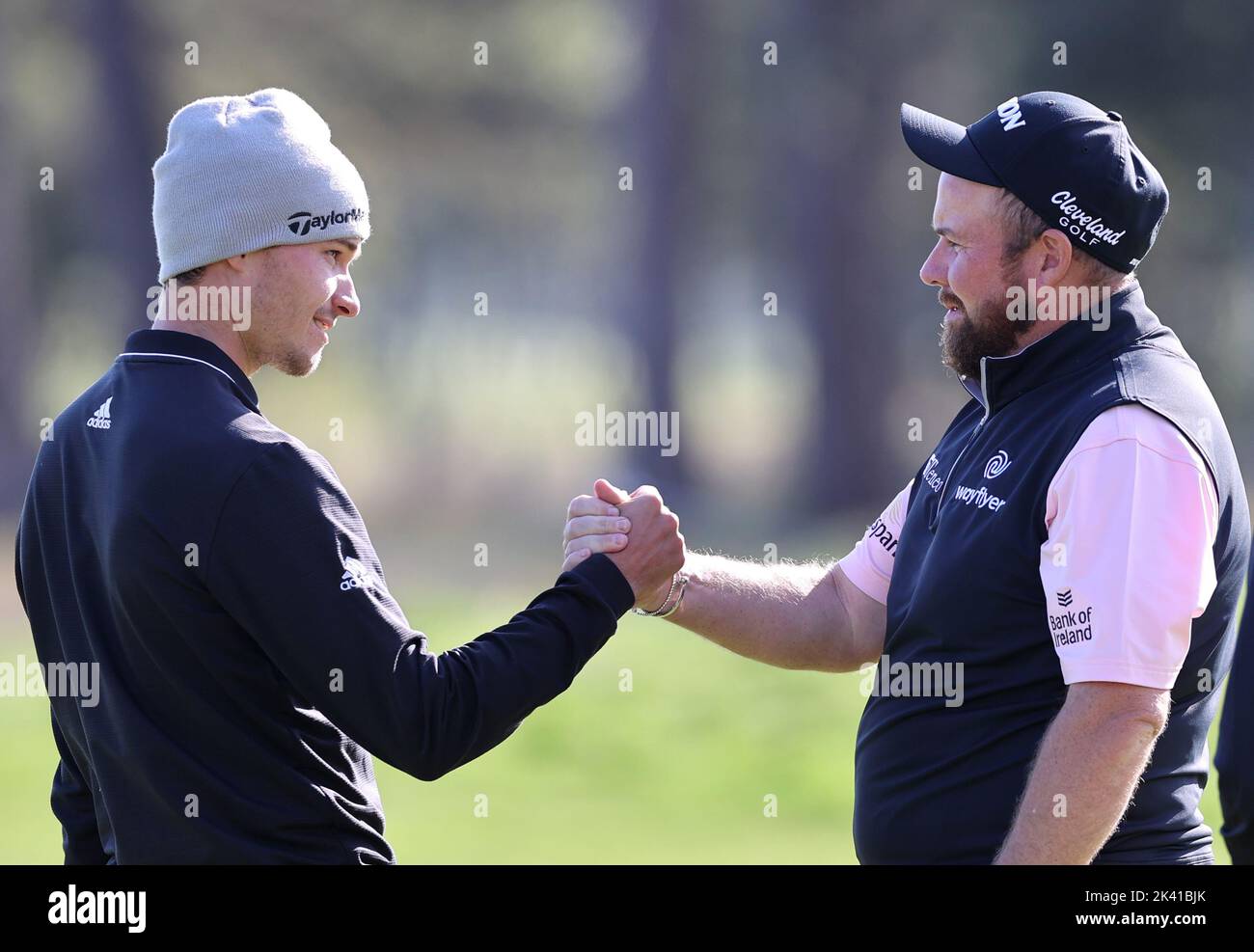 Rasmus Hojgaard shakes hands with Shane Lowry on day one of the Alfred ...