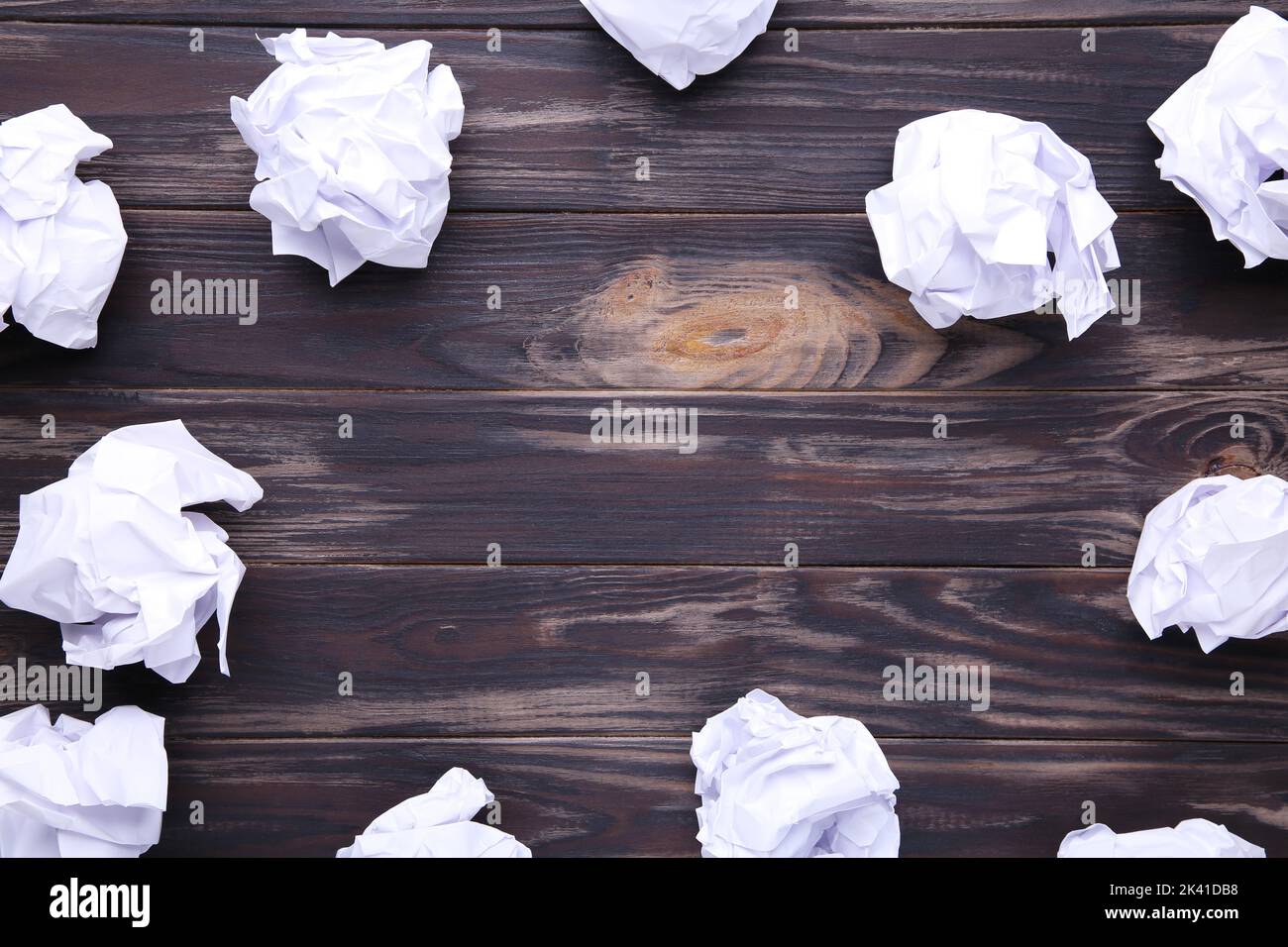Crumbled paper on a brown wooden background, frame Stock Photo - Alamy