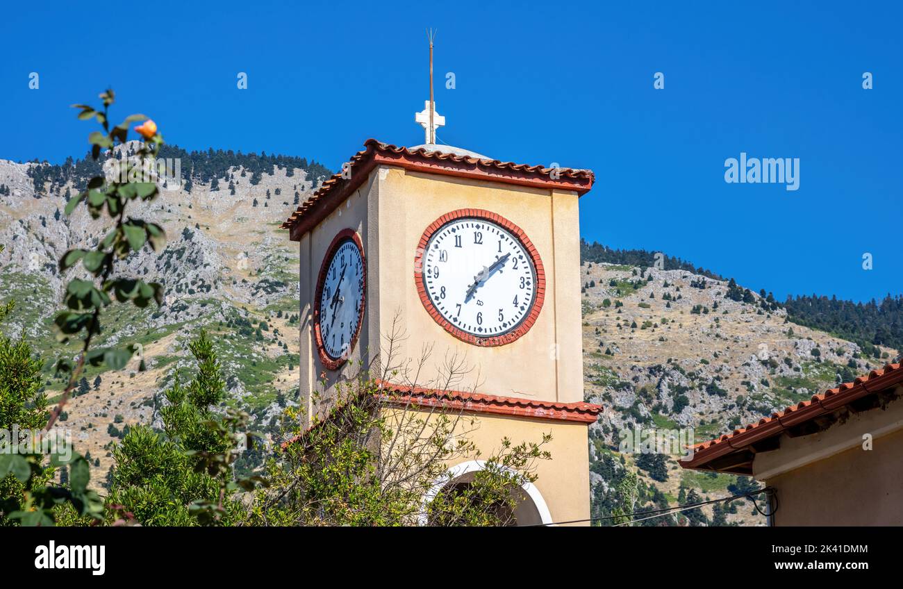 Clock on Orthodox church belfry. Bell tower with cross and clock at ...