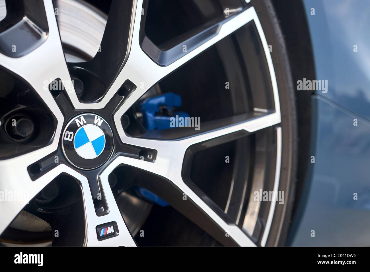 Berlin - August 2022: BMW 8 Series xDrive M-pack car closeup alloy wheel with low profile tires ...