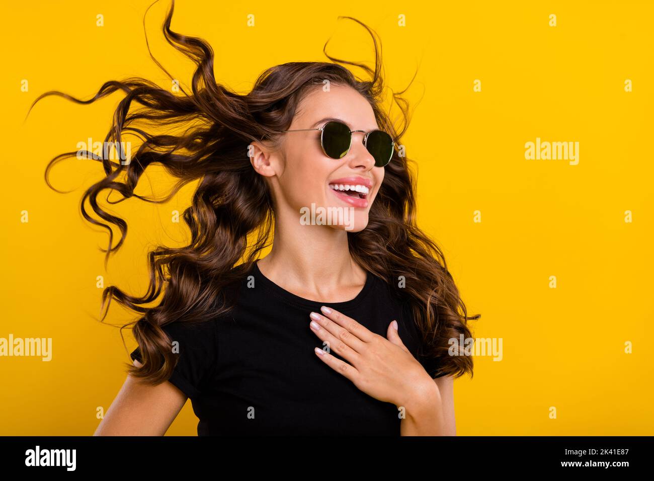 Photo of impressed pretty young woman wear black outfit dark eyeglasses ...
