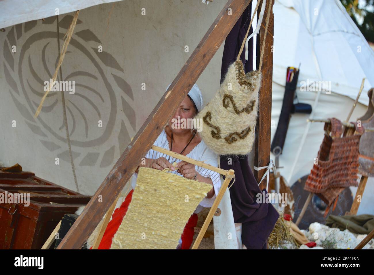 A traditional hand-weaving loom being used to make cloth Stock Photo ...