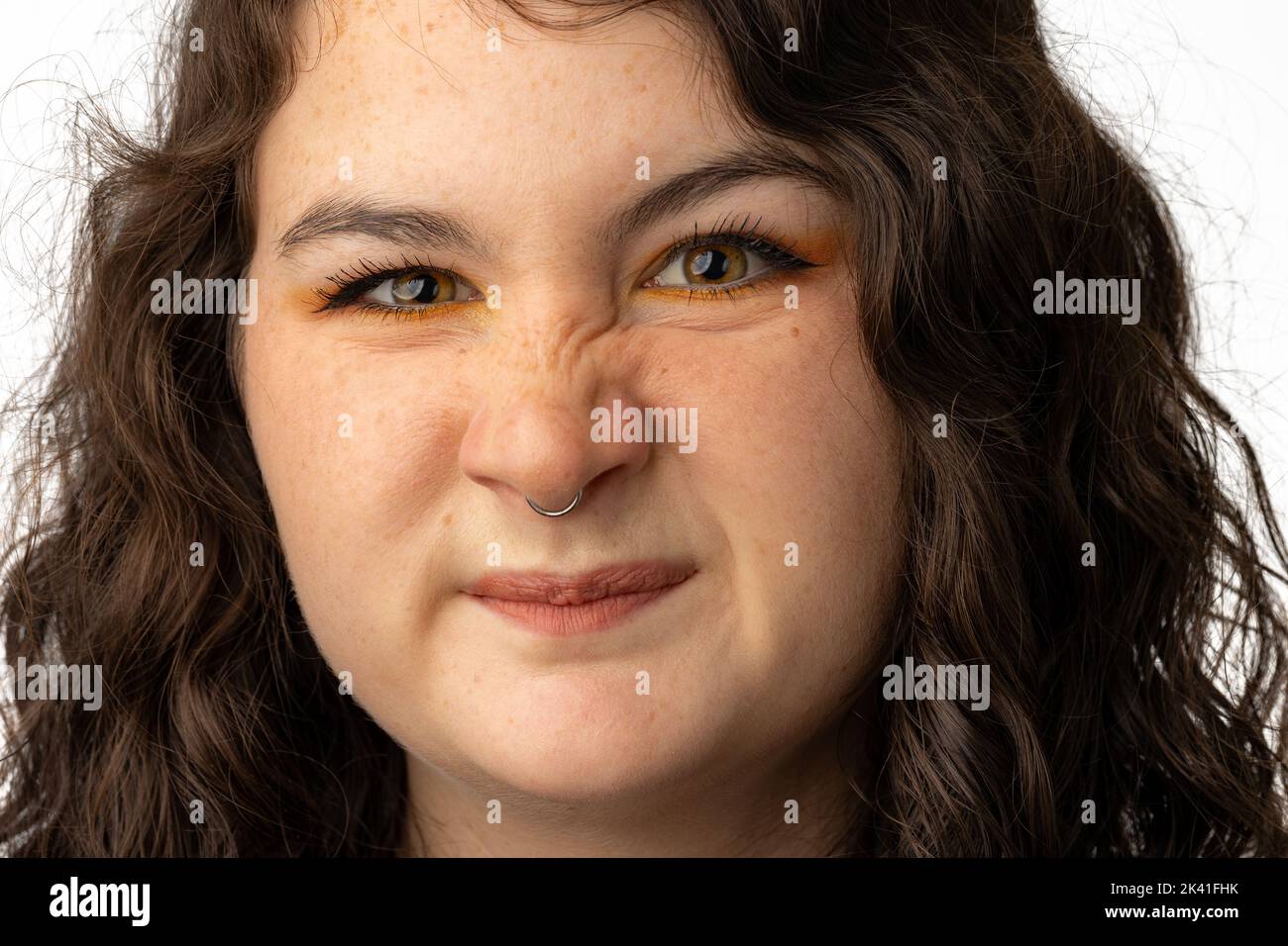 Young woman looking at camera with nose squished up Stock Photo - Alamy