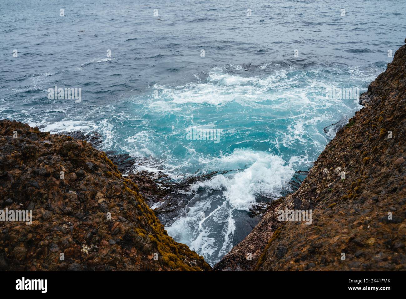 Point Lobos blue ocean waves against dark rocks and seaweed. Travelling ...