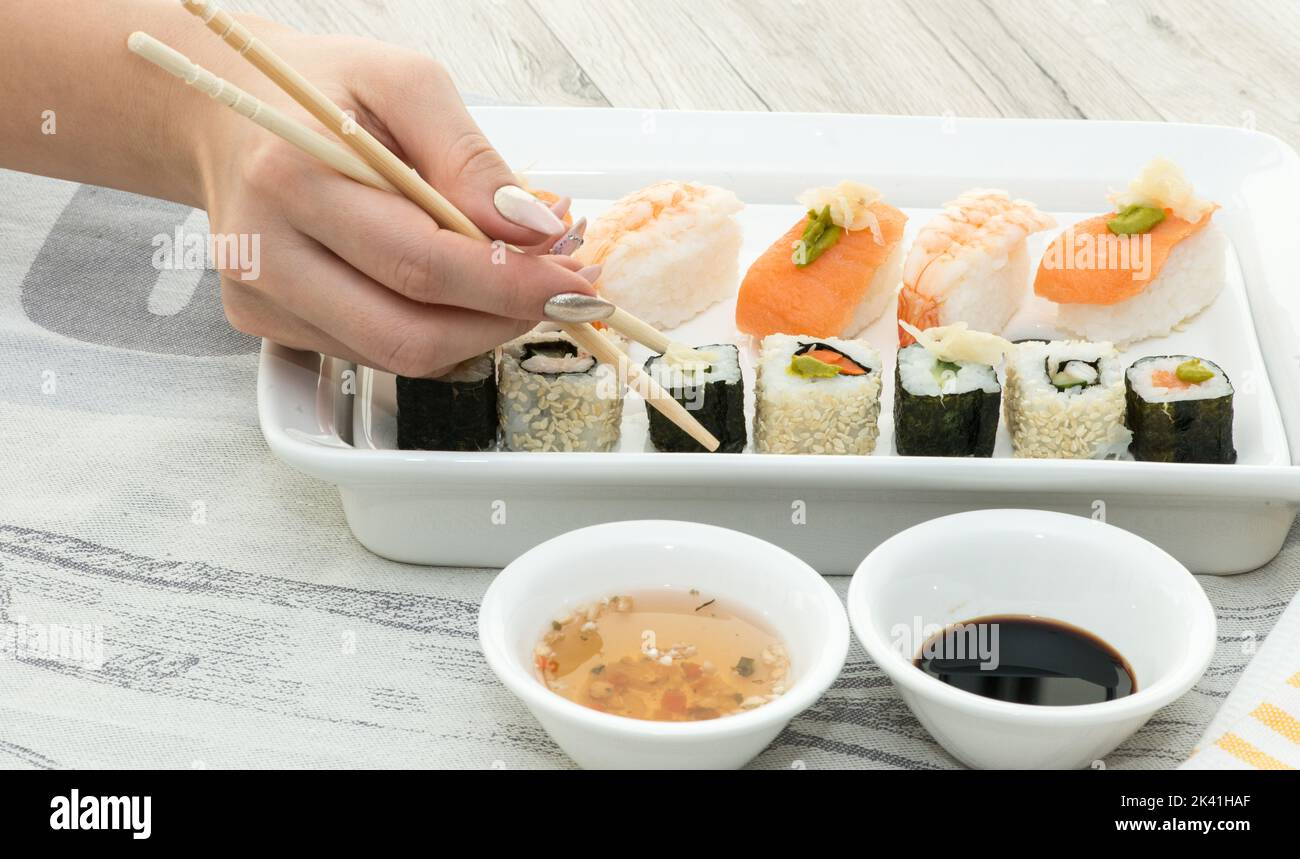 Woman serving sushi hi-res stock photography and images - Alamy