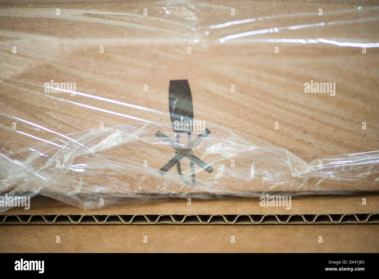 Cardboard with plastic foil Stock Photo - Alamy