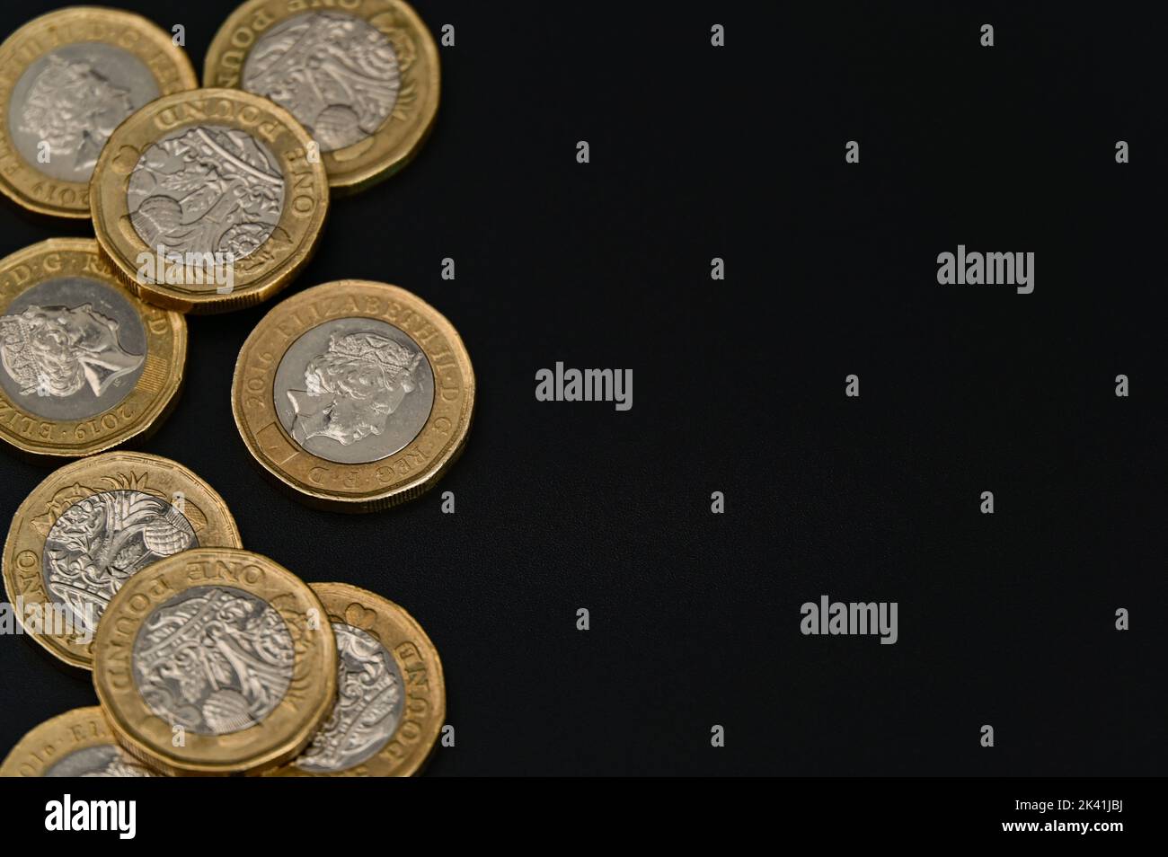 GBP British one pound coins currency money on a Black background Stock ...