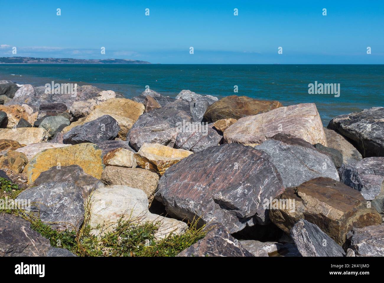 Piles of large boulders forming part of the sea defence wall at ...