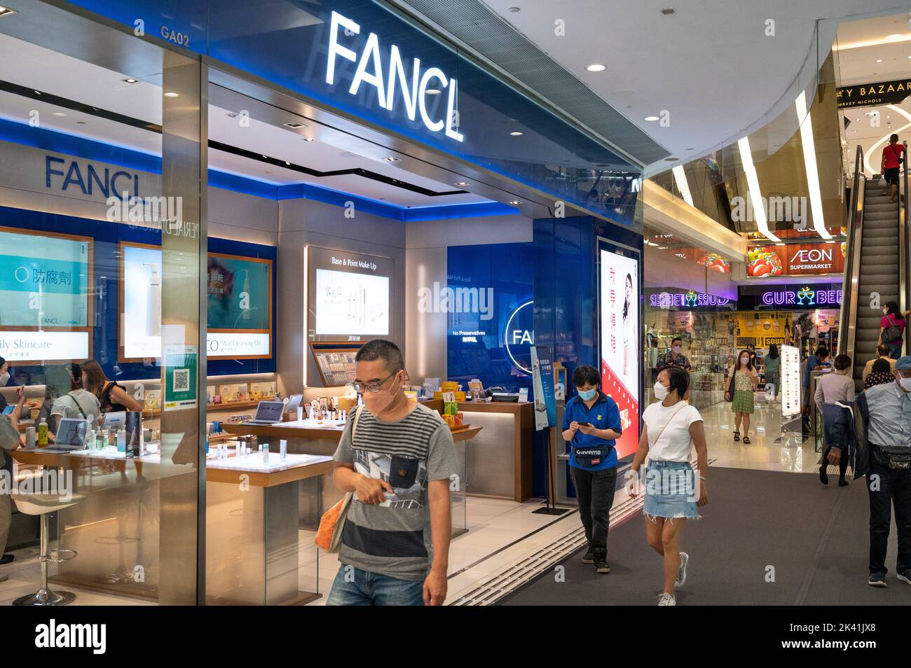 Shoppers walk past the Japanese cosmetics and dietary supplements ...