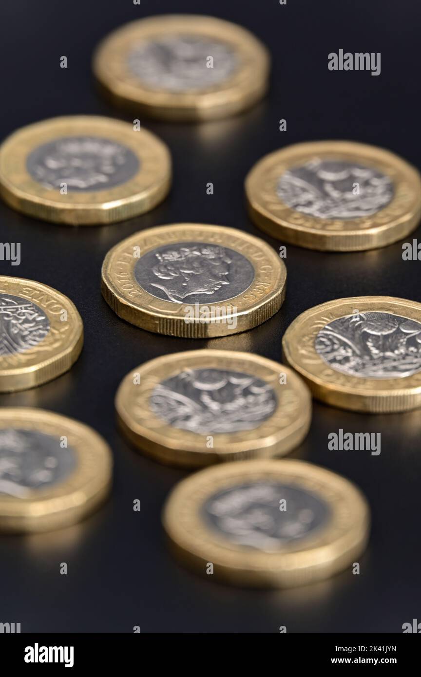 GBP British one pound coins currency money on a Black background Stock ...
