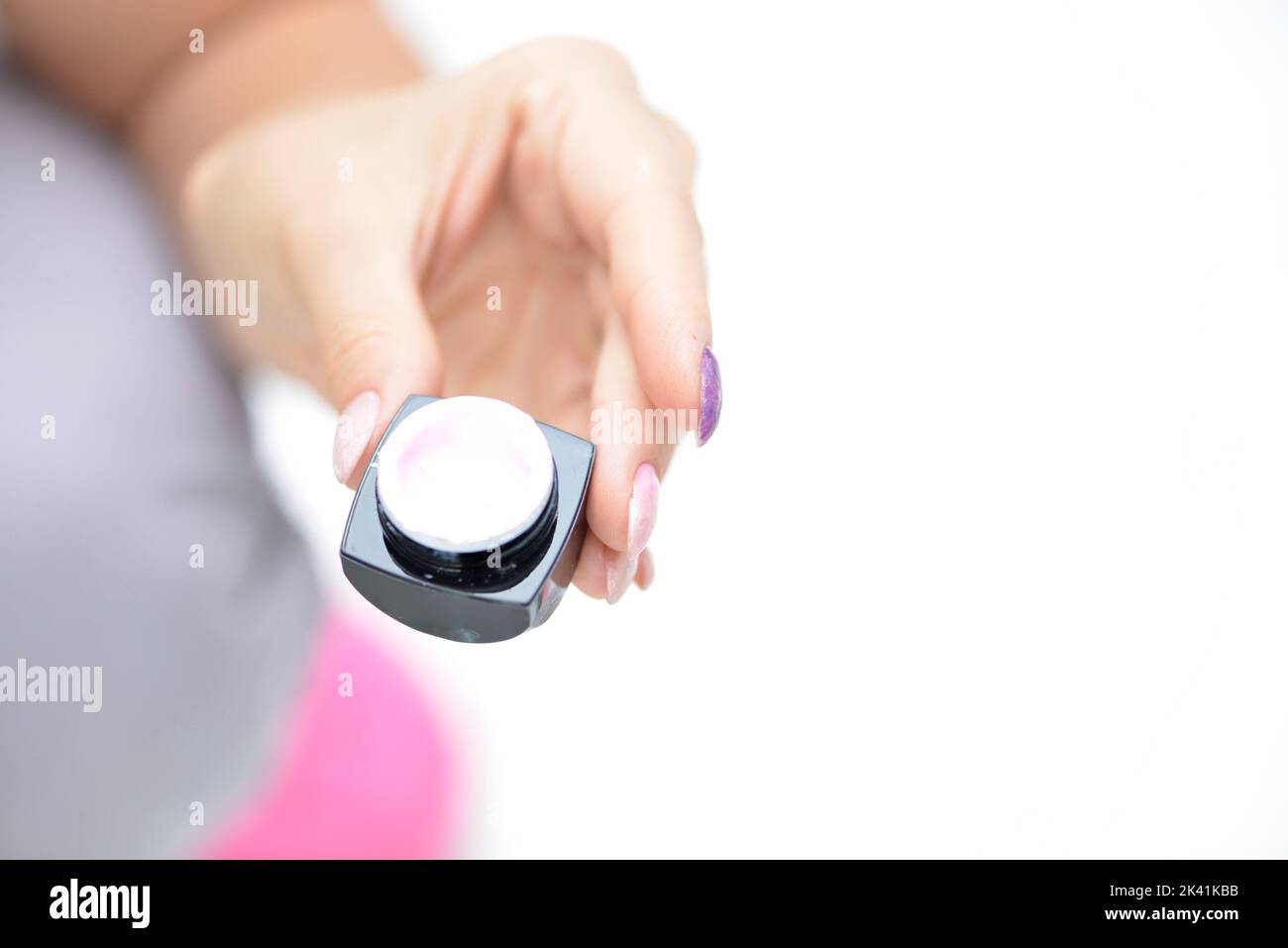 Uv Rose gel opened held in the palm Stock Photo - Alamy