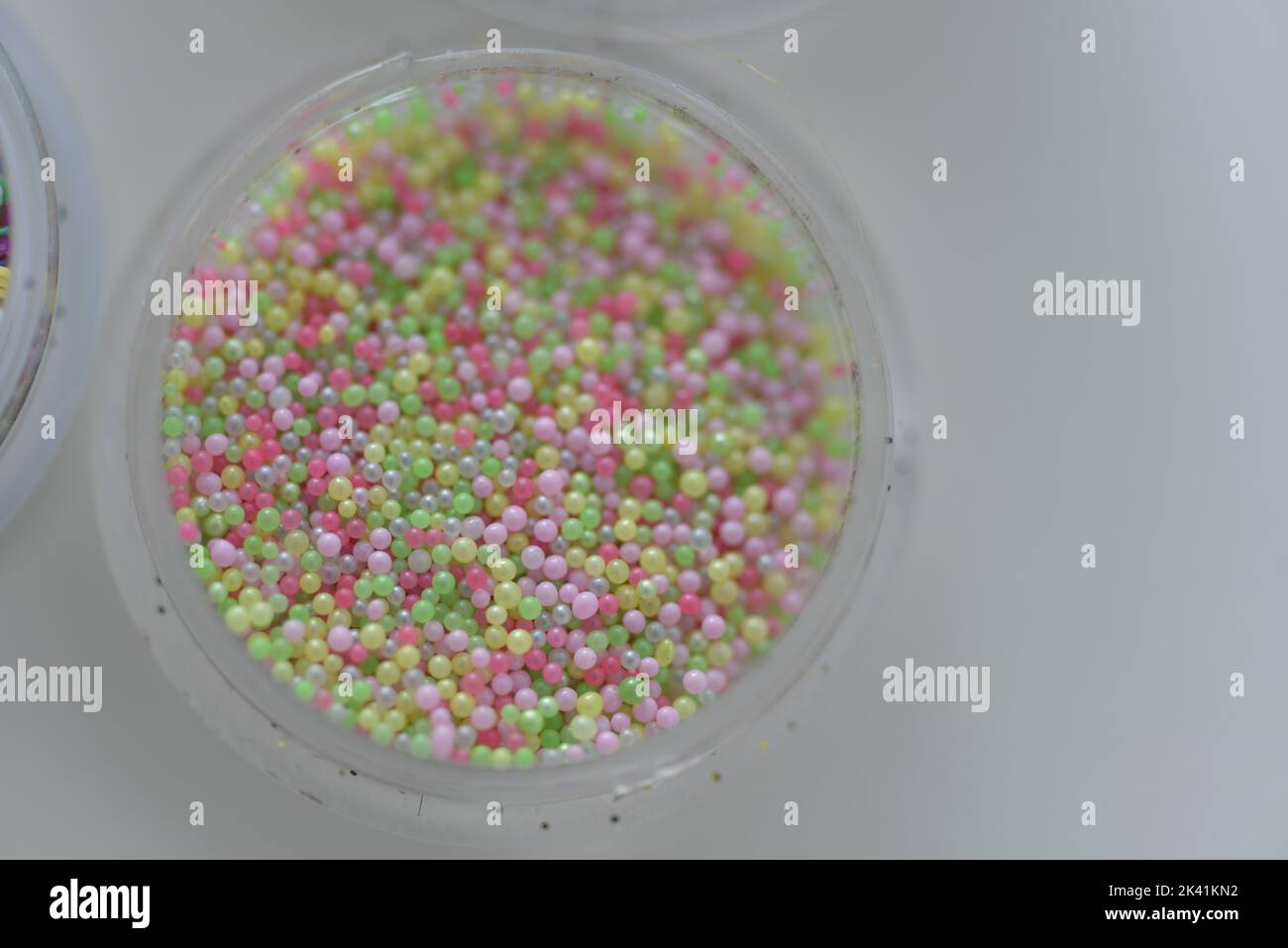 Small Glass Jars filled with Multicolored Balls of Bead Stock Photo - Alamy