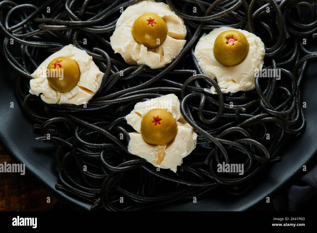 Halloween party Italian black pasta decorated horror olives like eyes ...