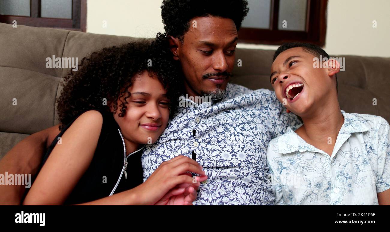 African father and children love and affection. Brazilian dad hugging ...