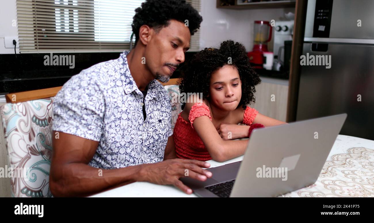 African father tutoring daughter girl in front of laptop computer2 Stock Photo - Alamy