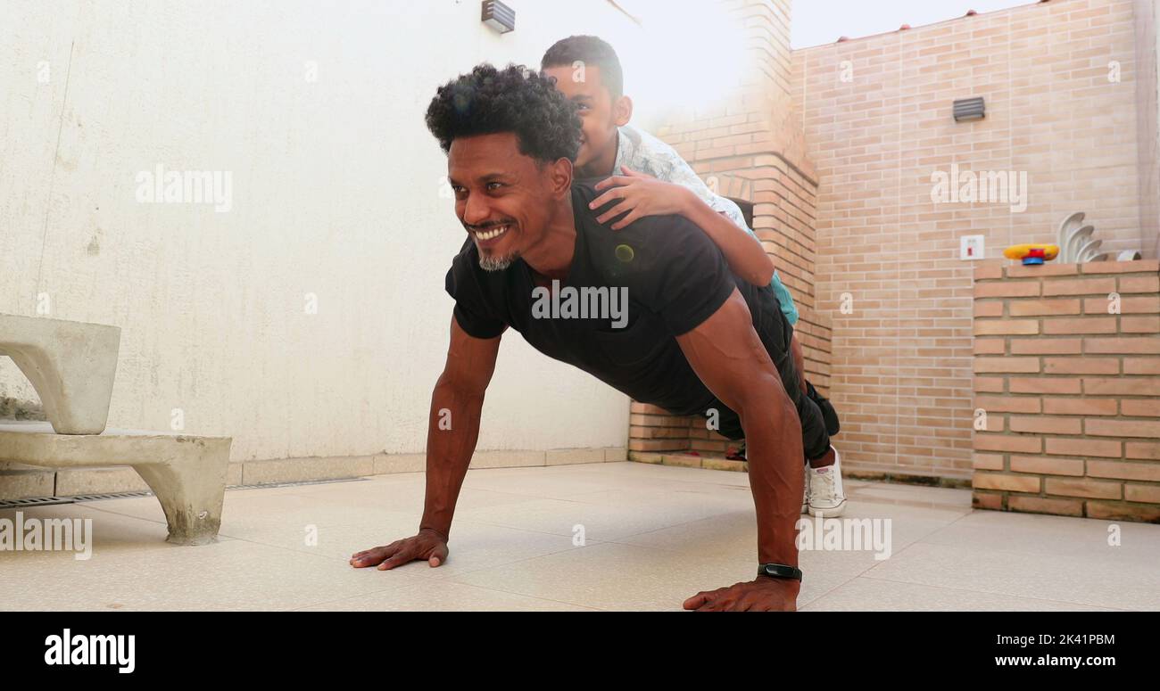 African father doing push up with son on back Stock Photo - Alamy
