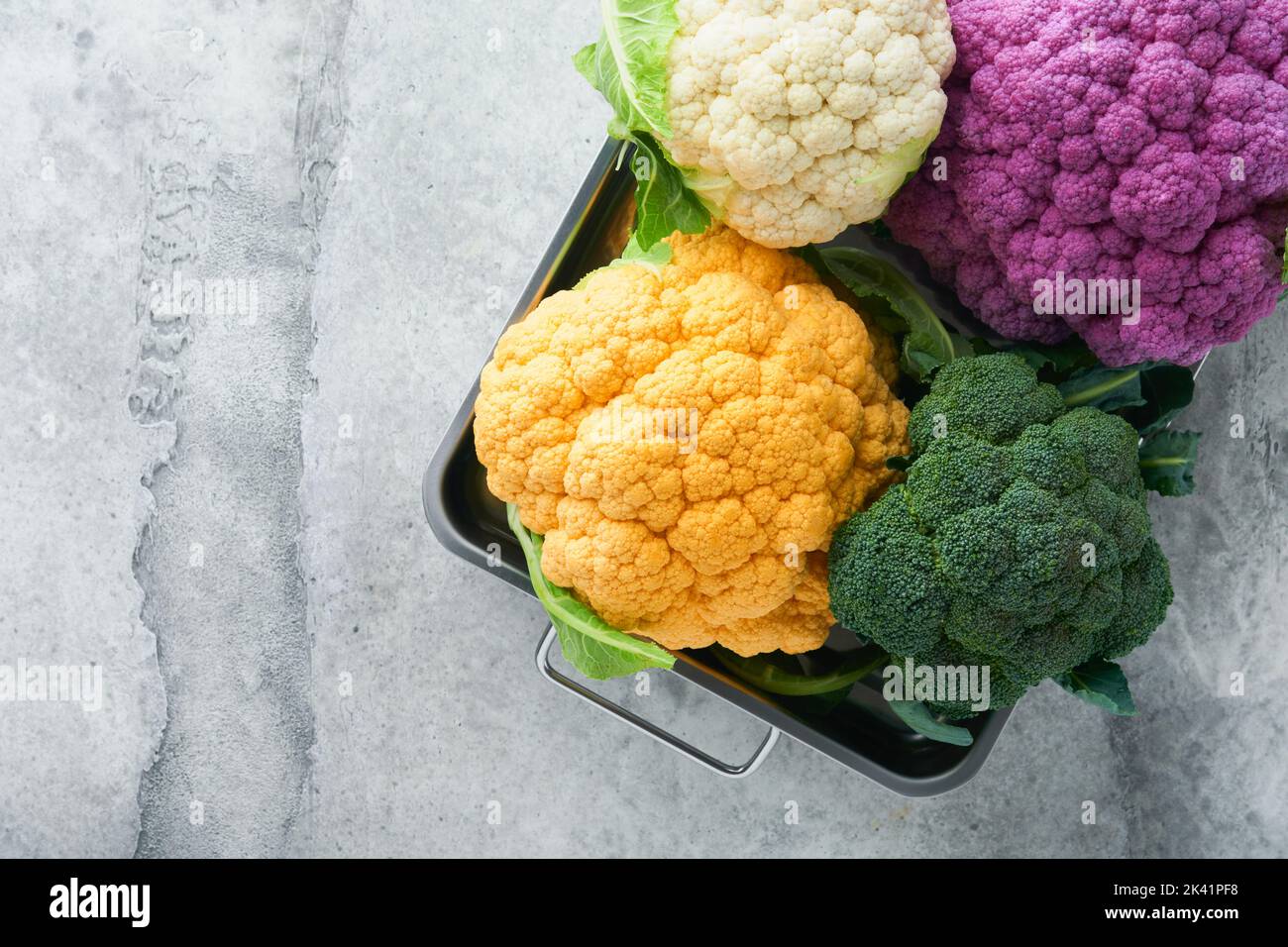 Colorfu cauliflower. Various sort of cauliflower on gray concrete ...