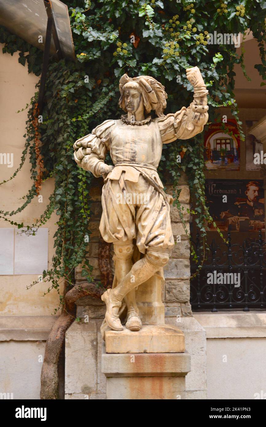 Statue in front of beautiful Peles castle Stock Photo - Alamy