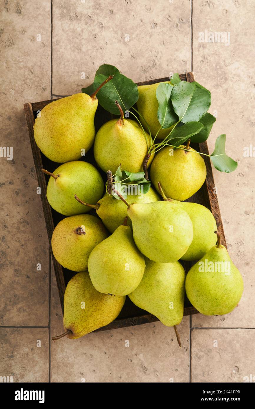 Pears. Fresh sweet organic pears with leaves in wooden box or basket on ...