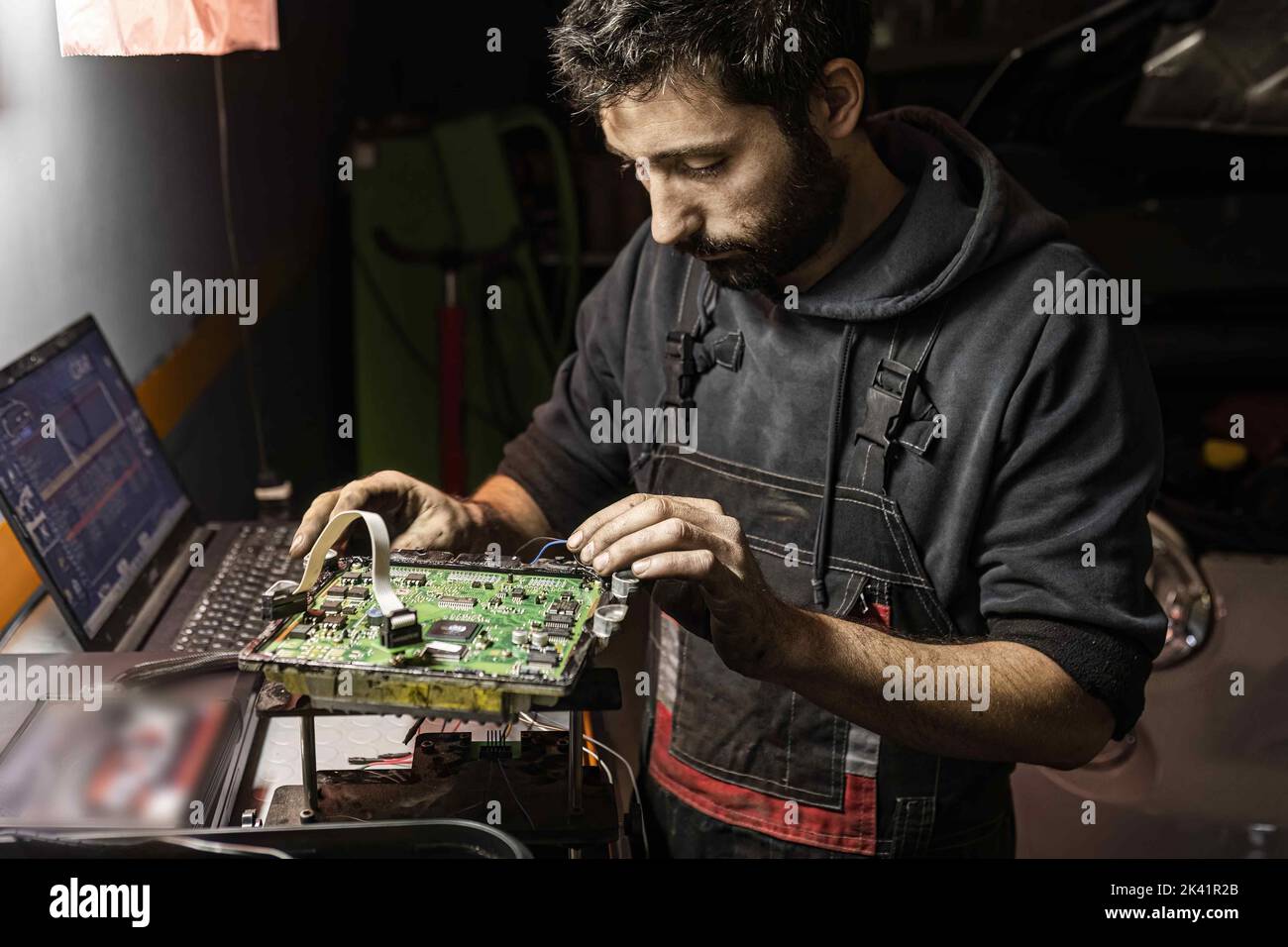 Mechanic performs car ecu remapping. Detail of Car ecu bench reading ...