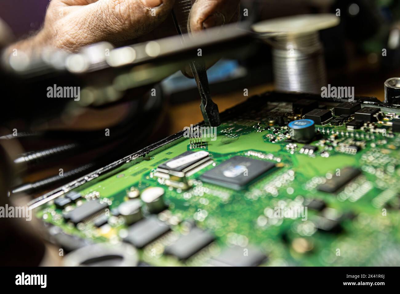 Car Ecu Detail with visible components with hand that repair it. Car ...