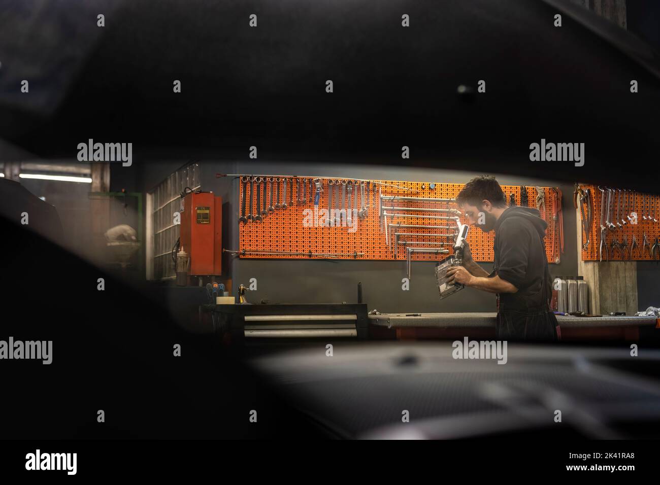 Mechanic works in his mechanical workshop. Car repair service Stock ...