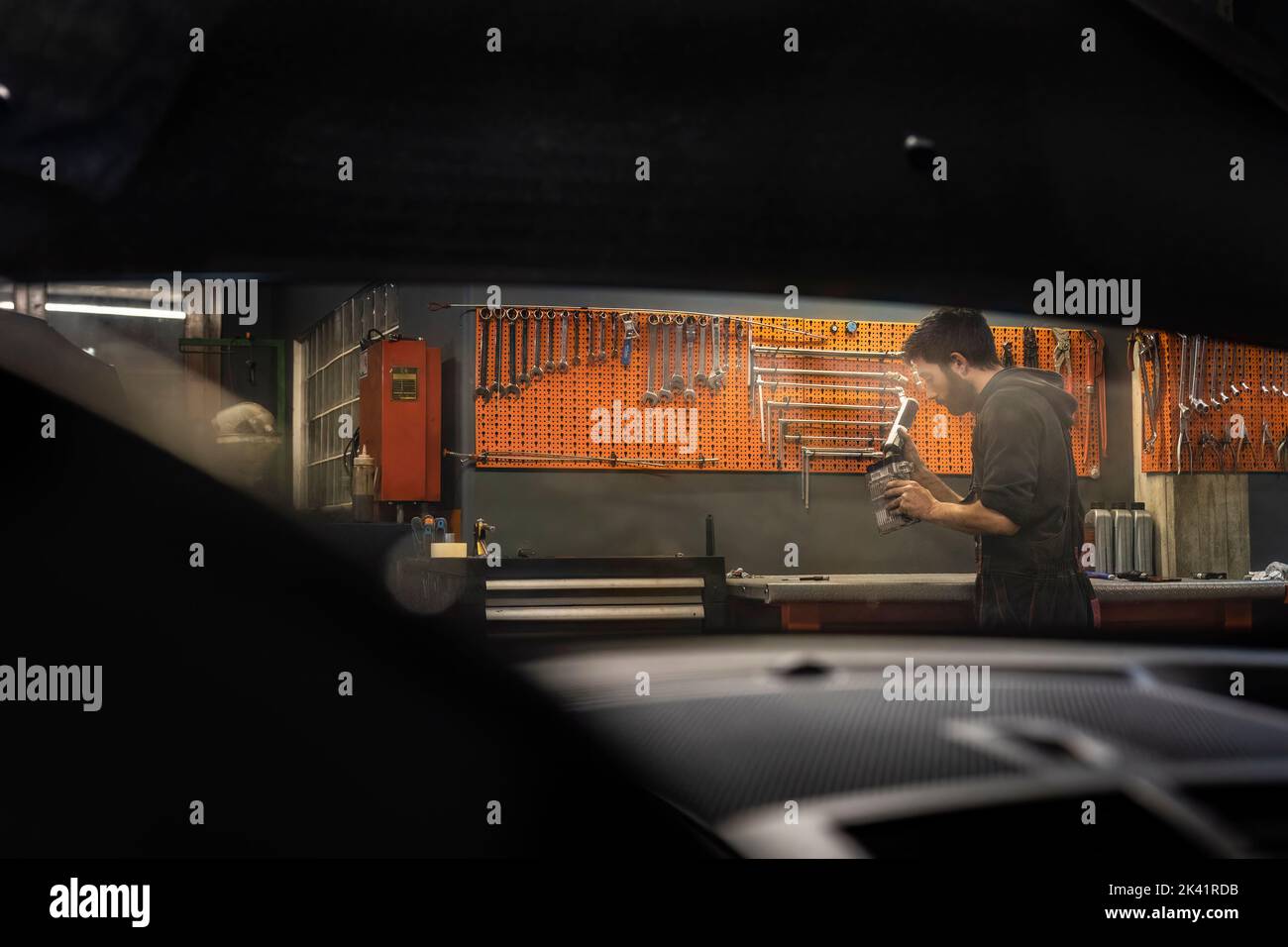 Mechanic works in his mechanical workshop. Car repair service Stock ...