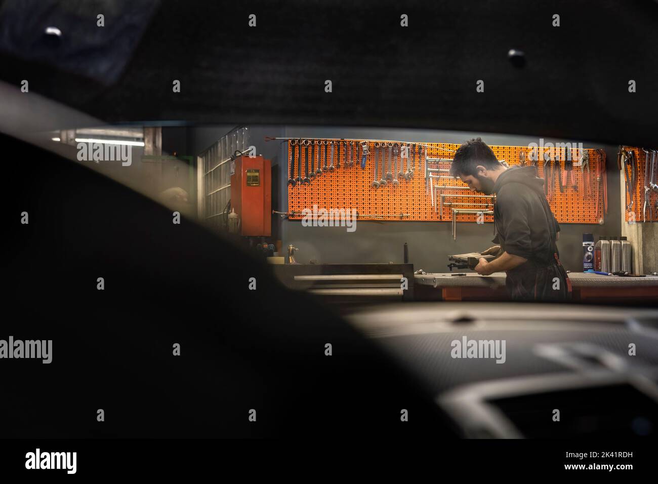 Mechanic works in his mechanical workshop. Car repair service Stock ...