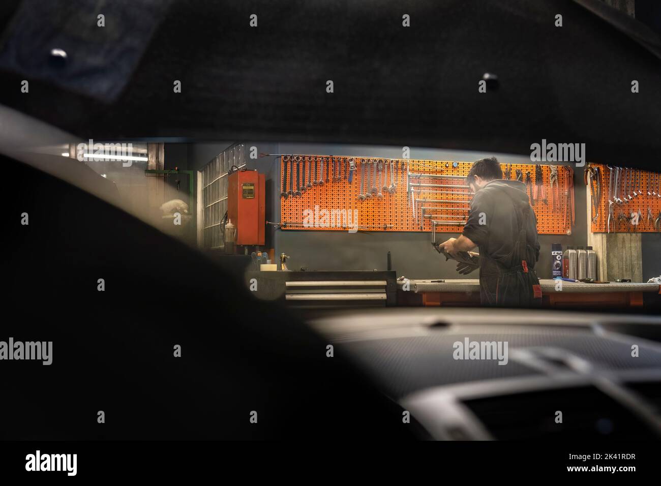 Mechanic works in his mechanical workshop. Car repair service Stock ...