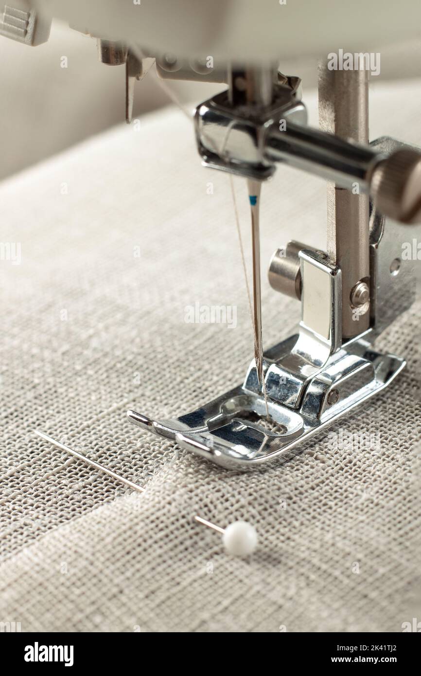 Modern sewing machine presser foot with linen fabric and thread ...