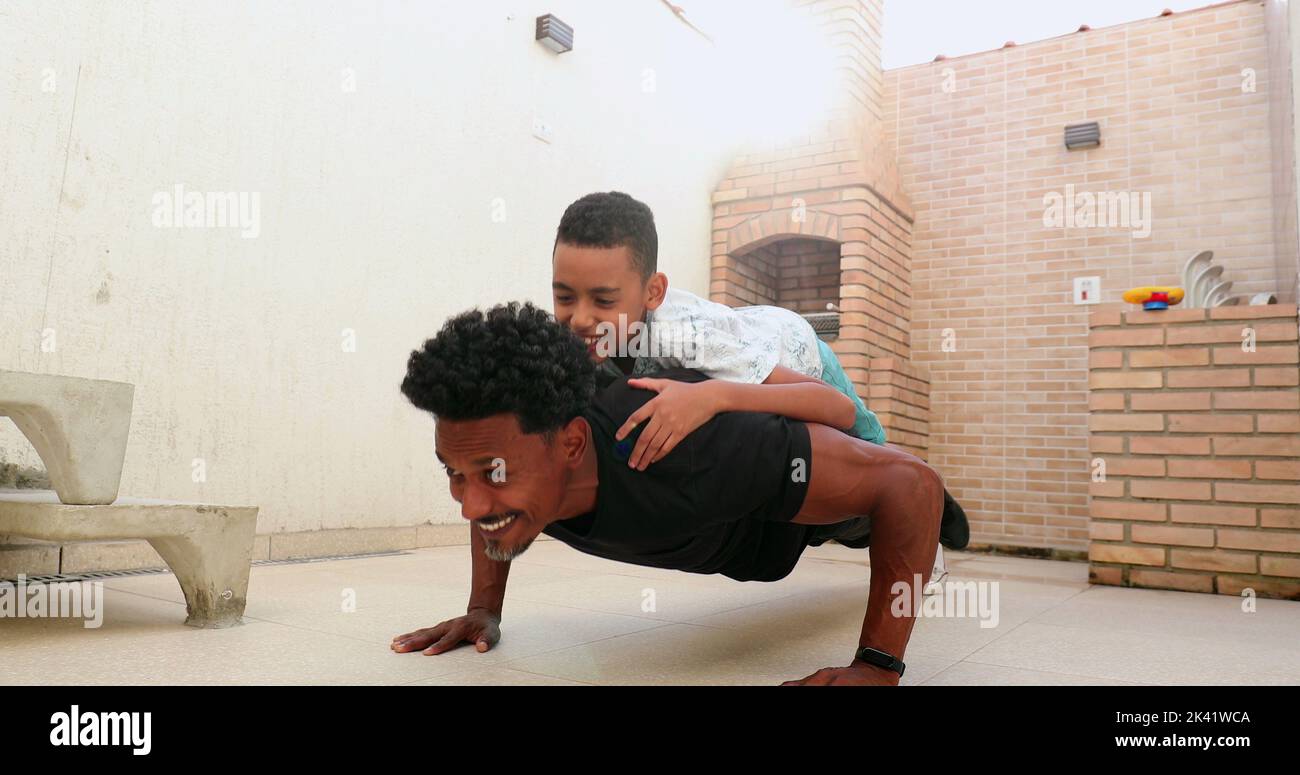 African father doing push up with son on back Stock Photo - Alamy