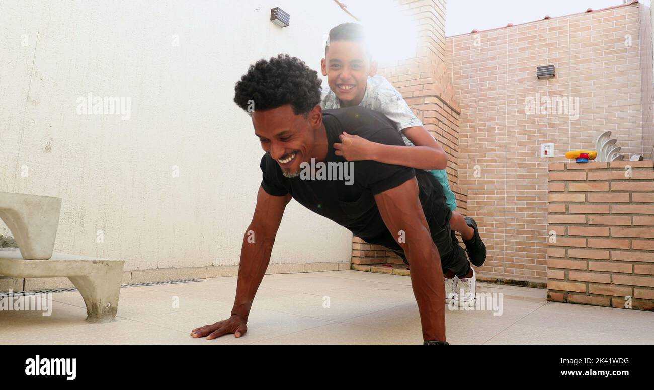 African father doing push up with son on back Stock Photo - Alamy