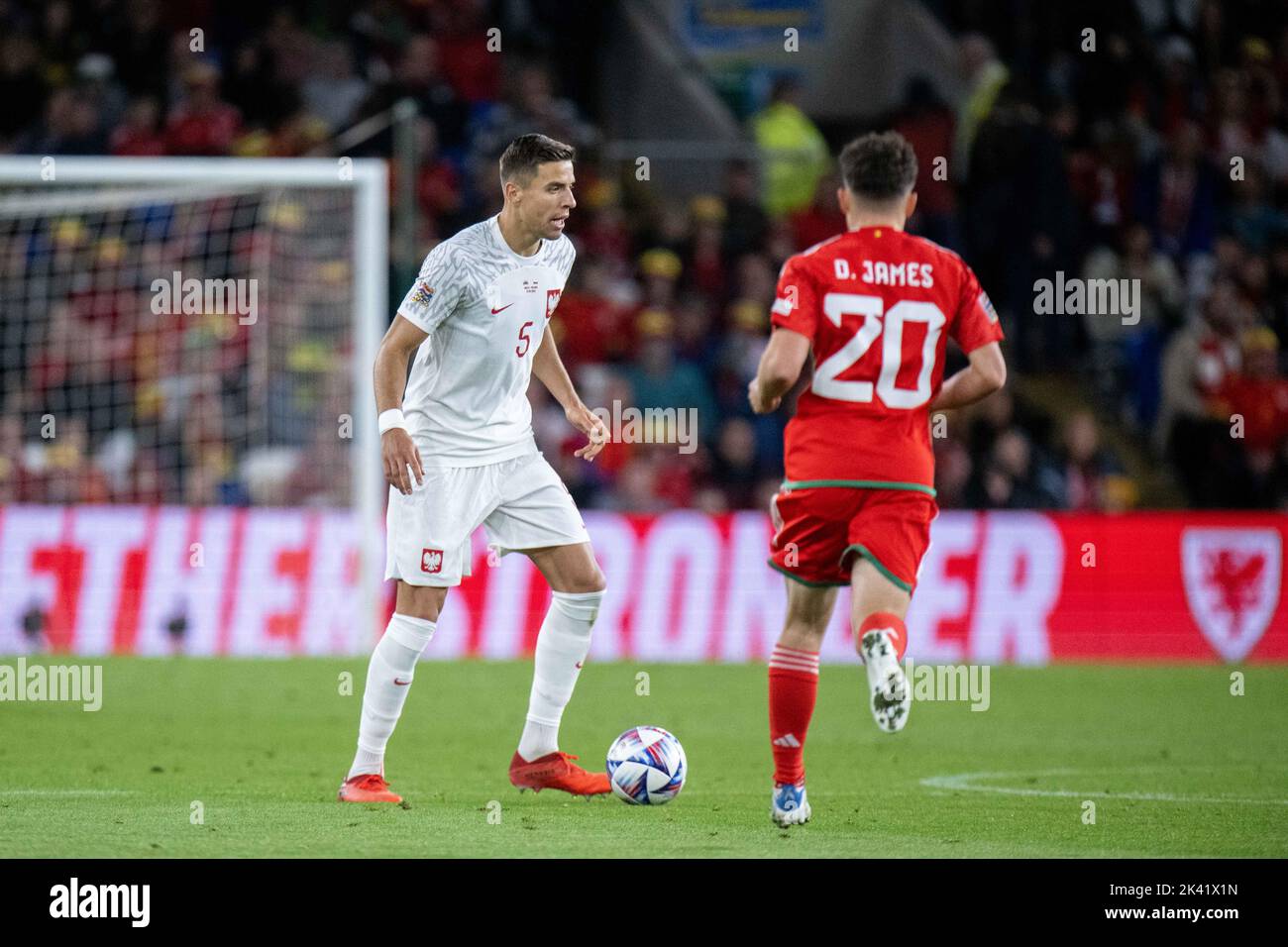 CARDIFF, WALES - SEPTEMBER 25: Jan Bednarek of Poland and Daniel James ...
