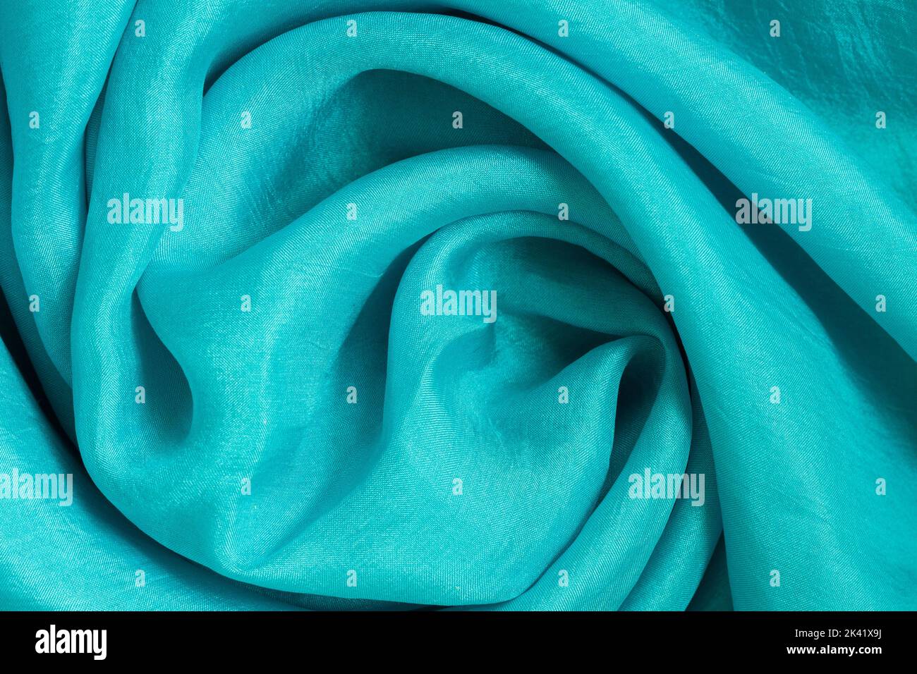 Fabric twisted in spiral waves, fashion trendy tourmaline color Stock ...