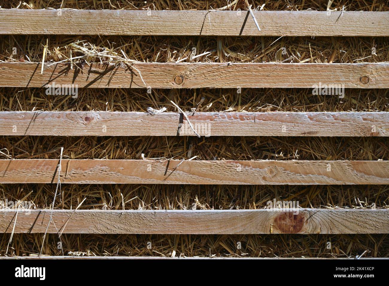 Fence planks on a background of dry straw Stock Photo - Alamy