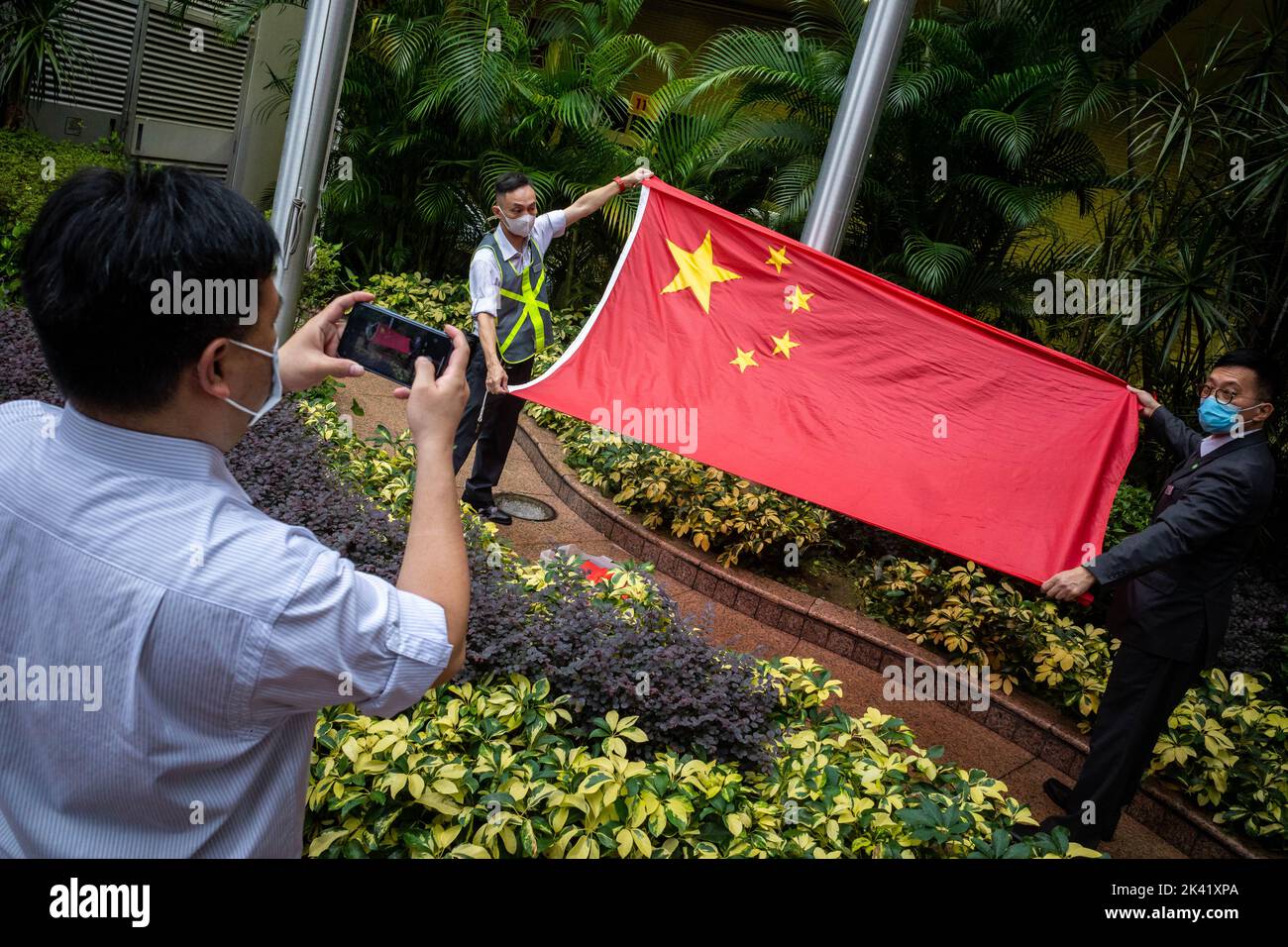 Hong Kong, China. 27th Sep, 2022. Workers at Taikoo Place take a photo ...