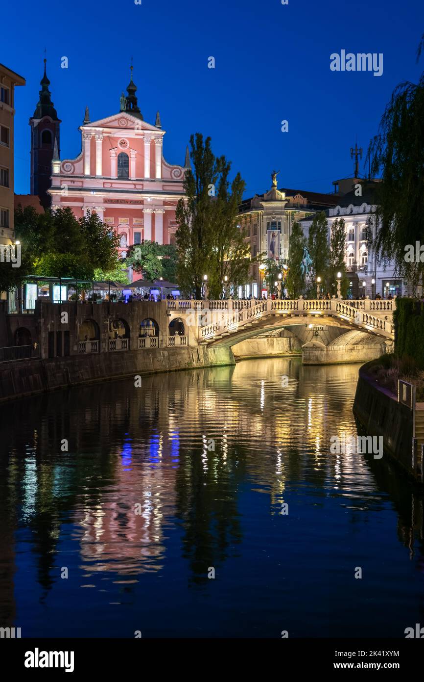 City of Ljubljana by night in Slovenia, illuminated Triple Bridge over ...