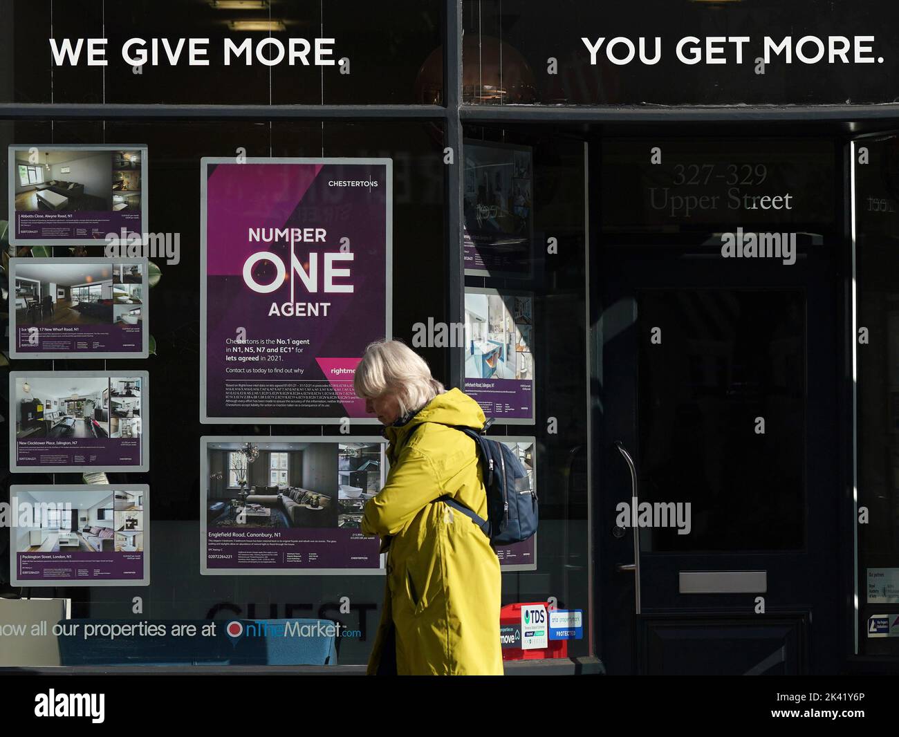 A general of a person walking past advertisements in a estate agents ...