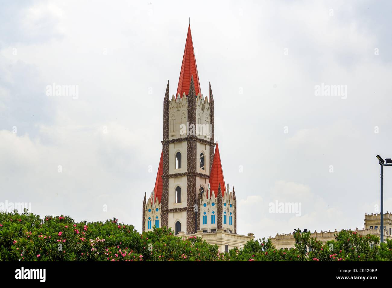 A red gothic steeple church building Stock Photo - Alamy