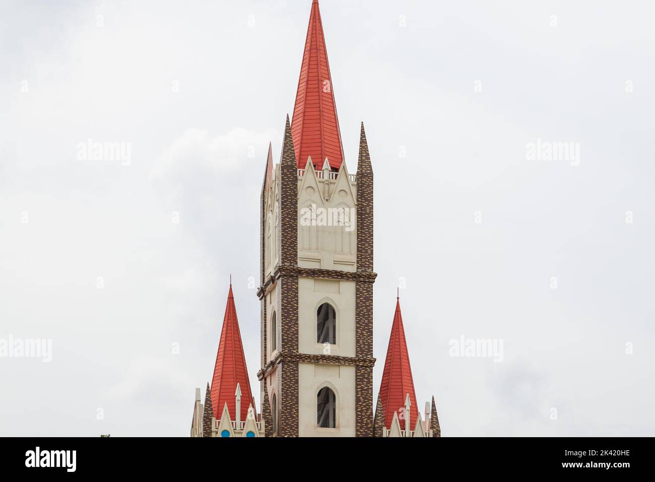 A red gothic steeple church building Stock Photo - Alamy
