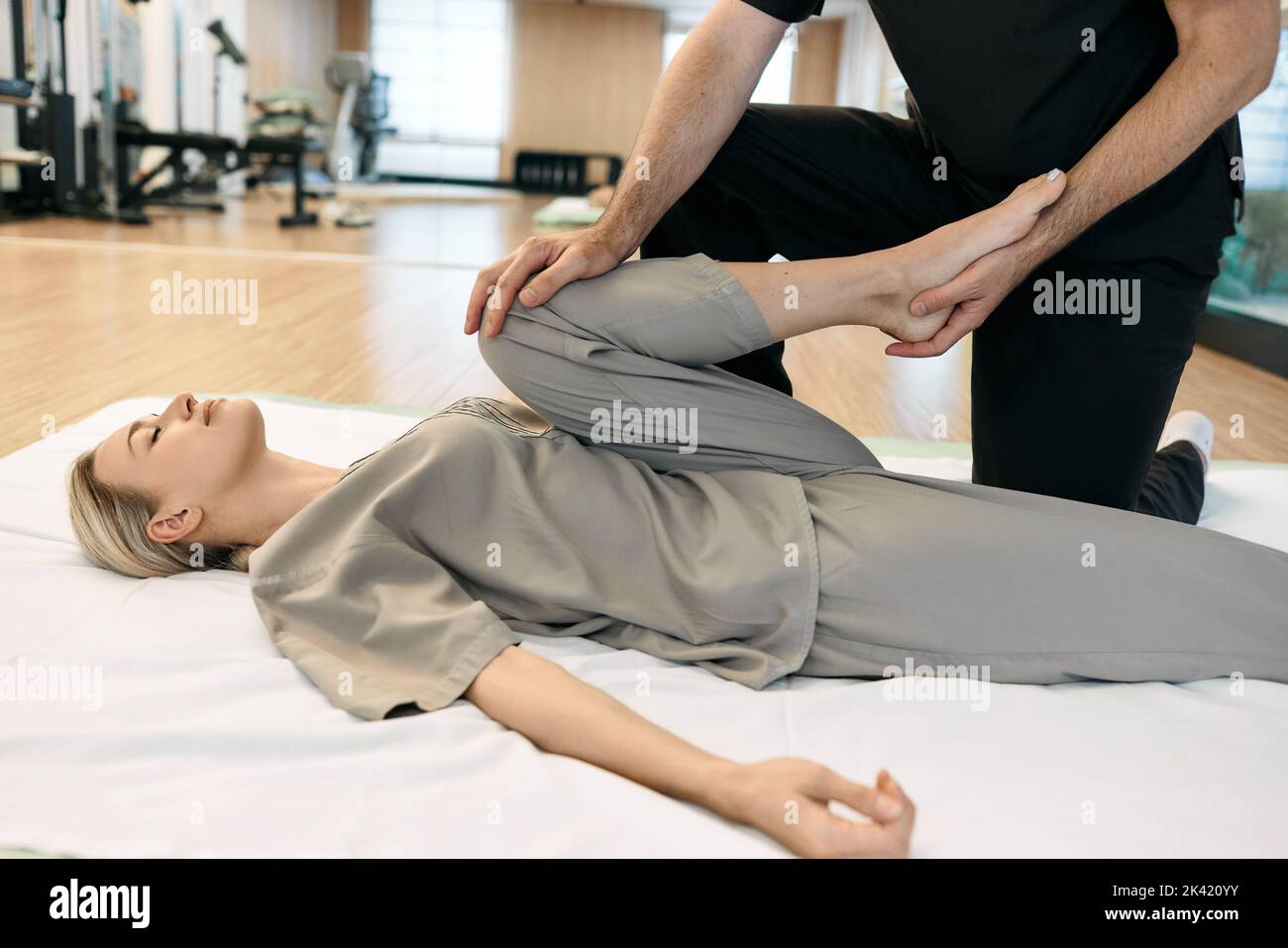 Massage therapist using Japanese techniques Yumeiho pressing on female ...