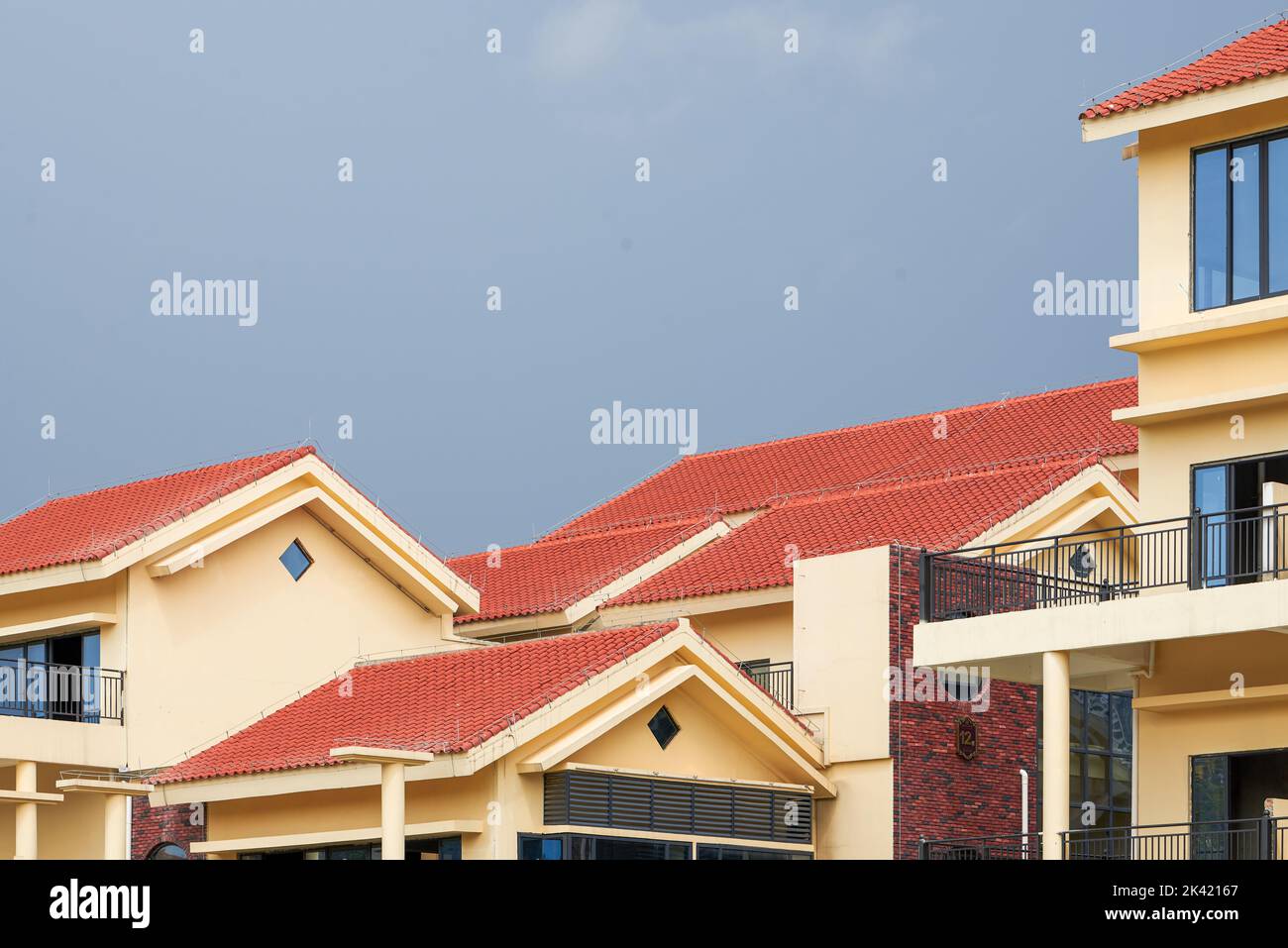 Red roof brick modern building in the city Stock Photo - Alamy