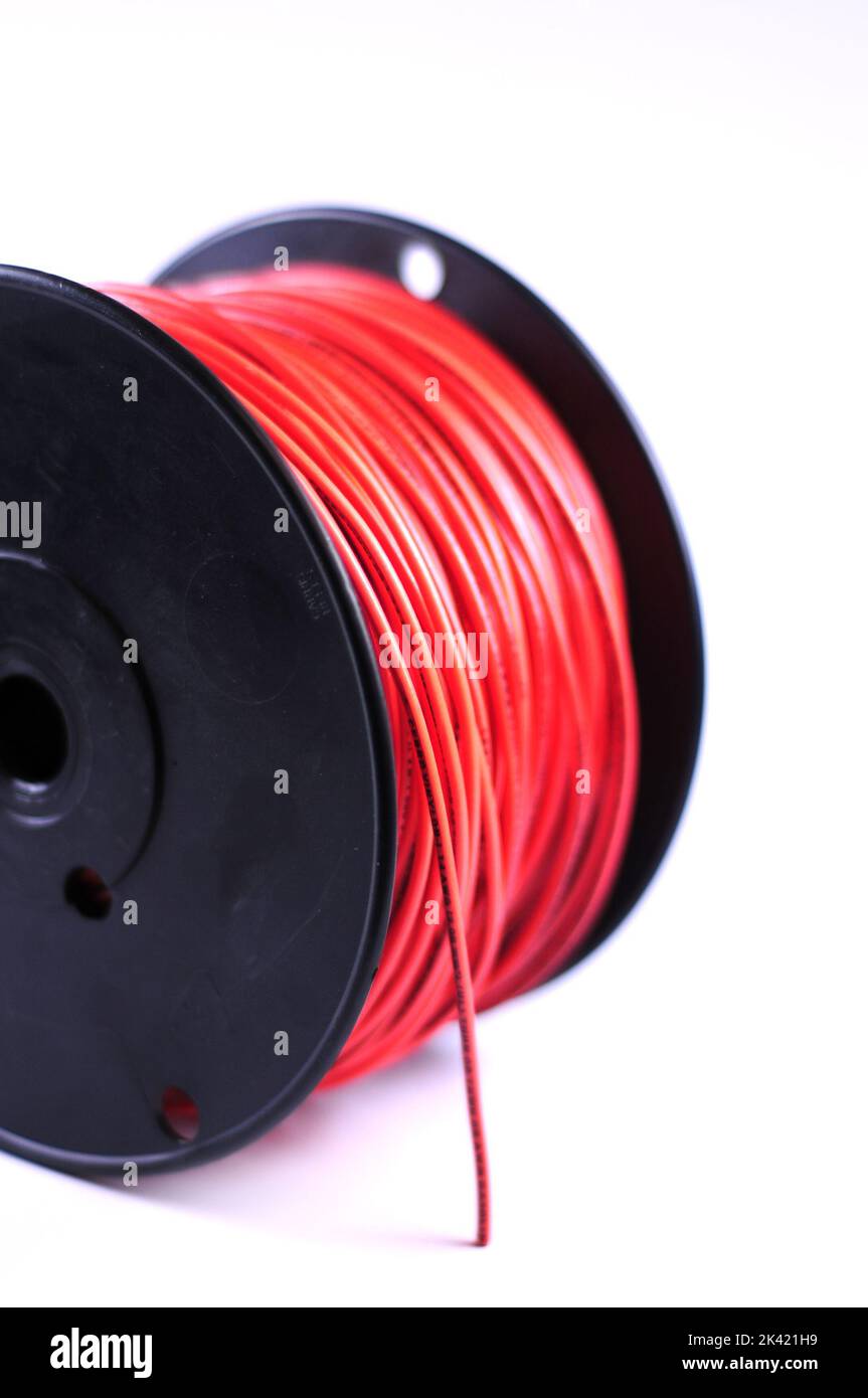 A bobbin of red wire. Isolated on pure white Stock Photo - Alamy