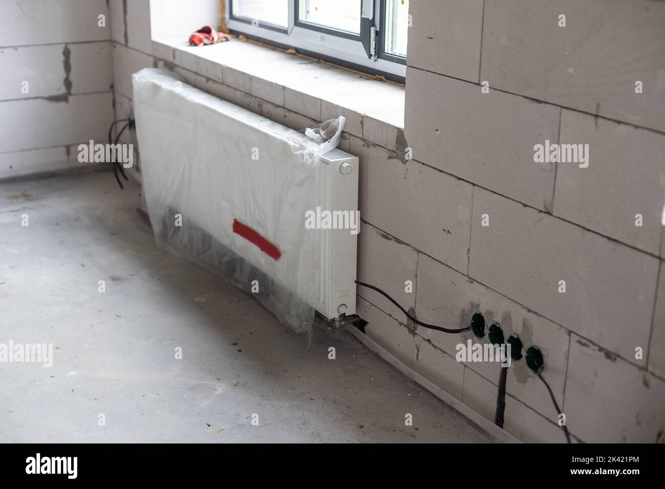 new white heat radiators hang on the wall under the window under ...