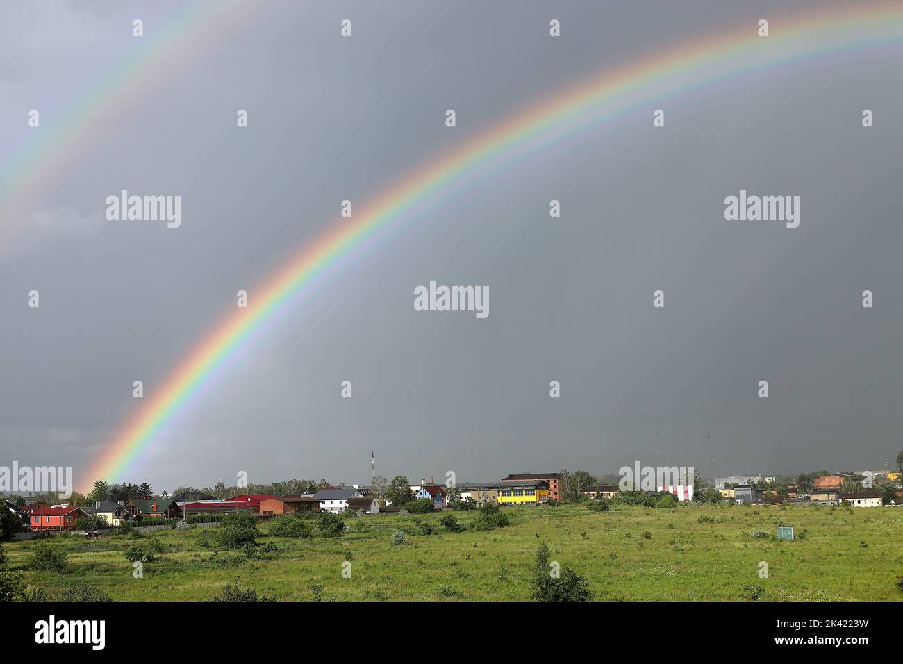 Bright double rainbow with dark rain clouds in the nature background ... Bright double rainbow with dark rain clouds in the nature background ...