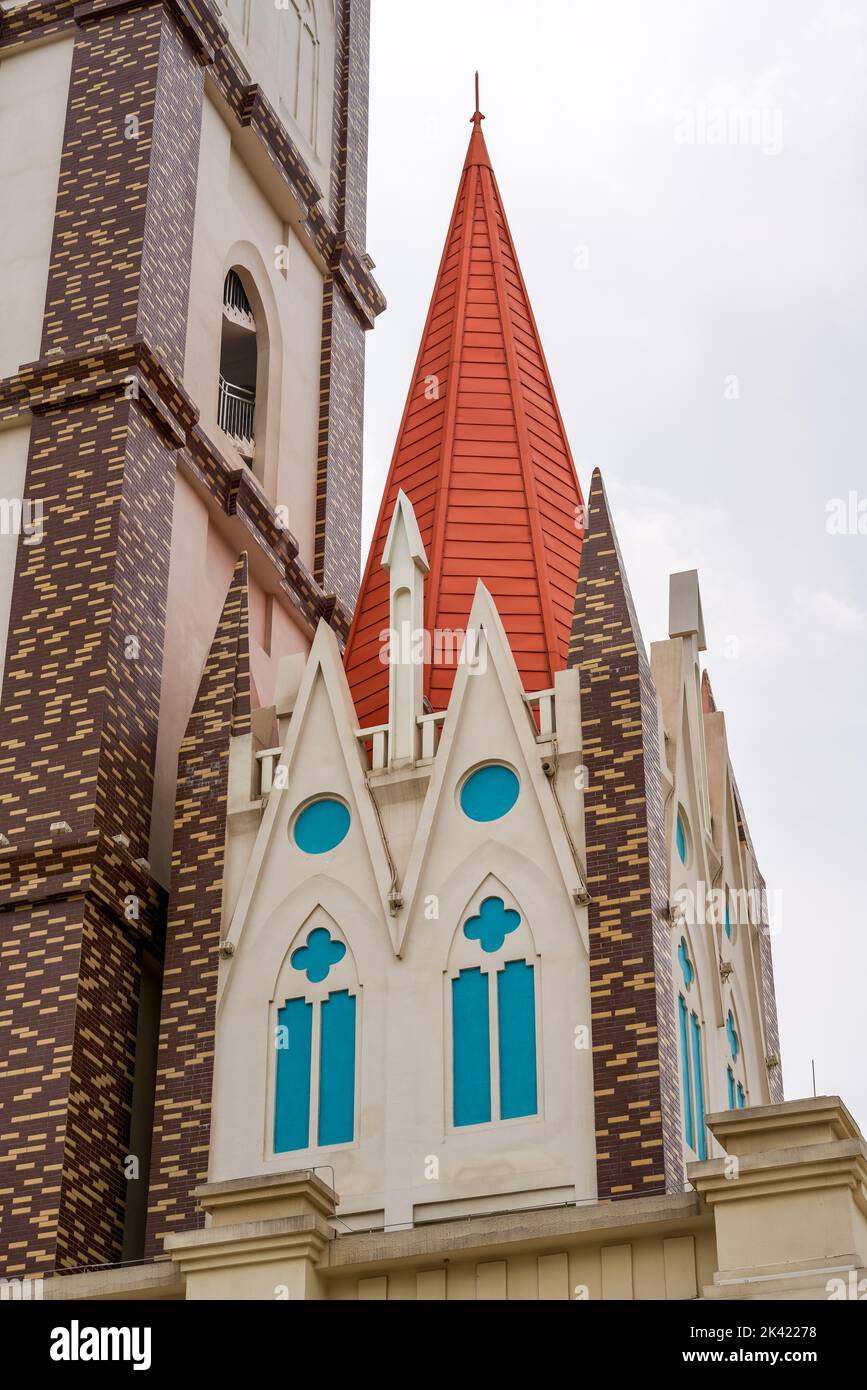 A red gothic steeple church building Stock Photo - Alamy