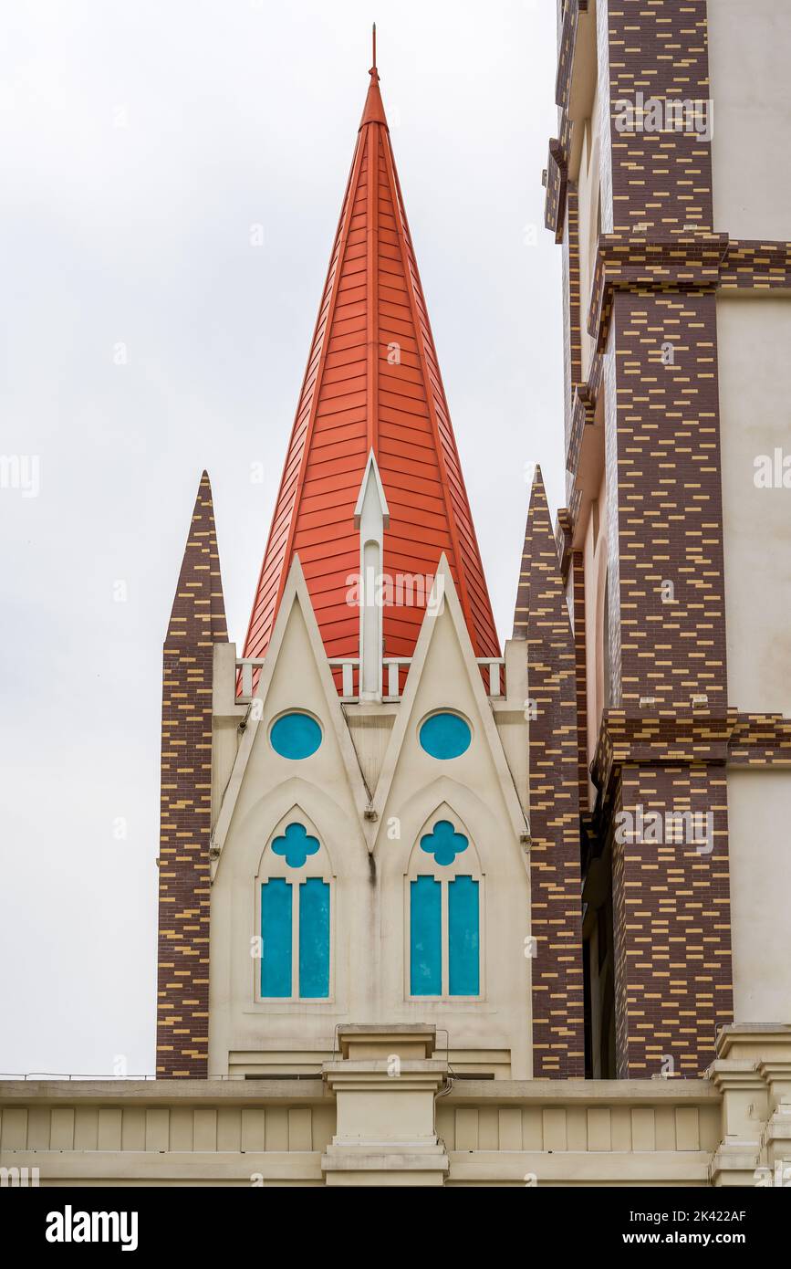 A red gothic steeple church building Stock Photo - Alamy