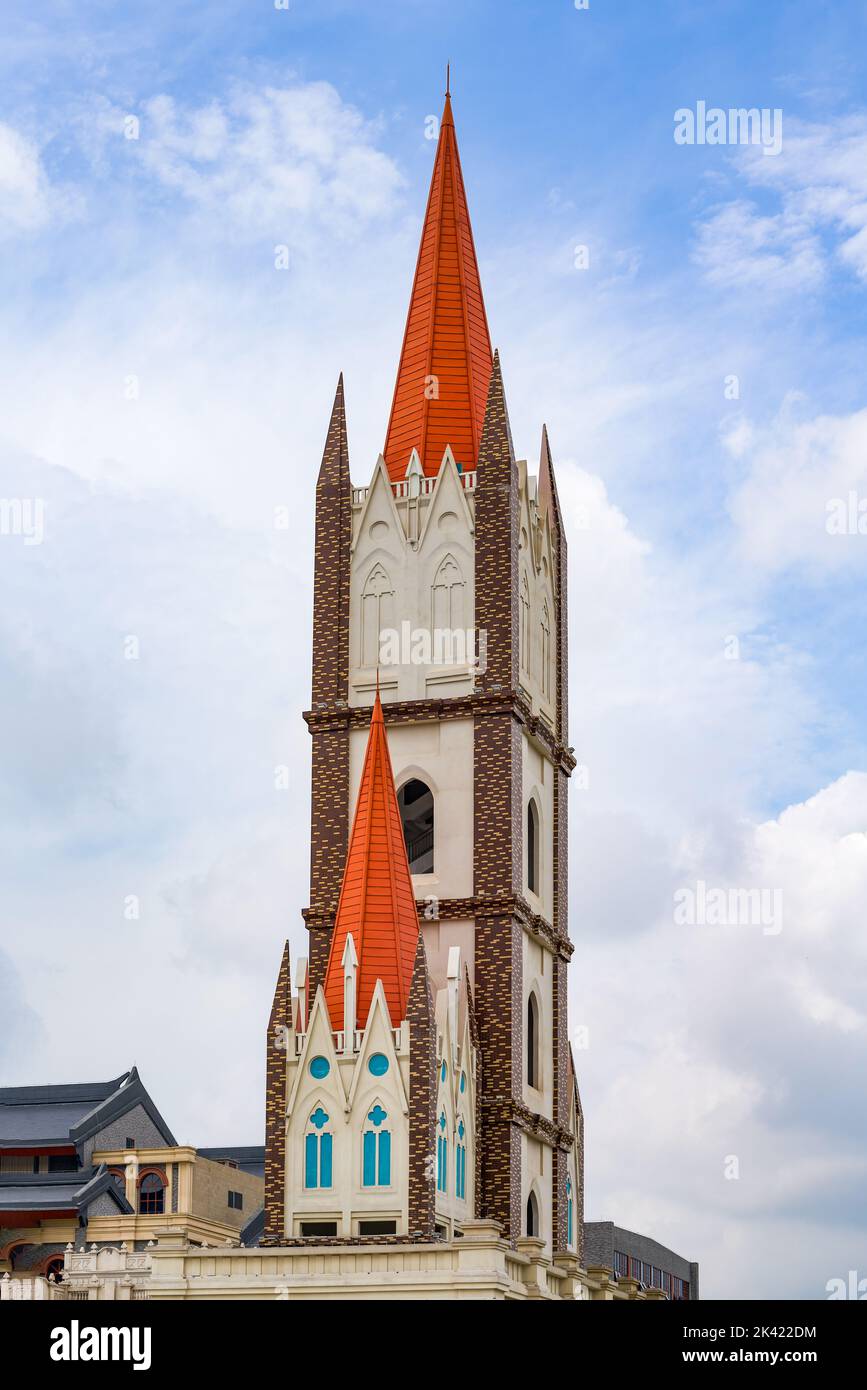 A red gothic steeple church building Stock Photo - Alamy