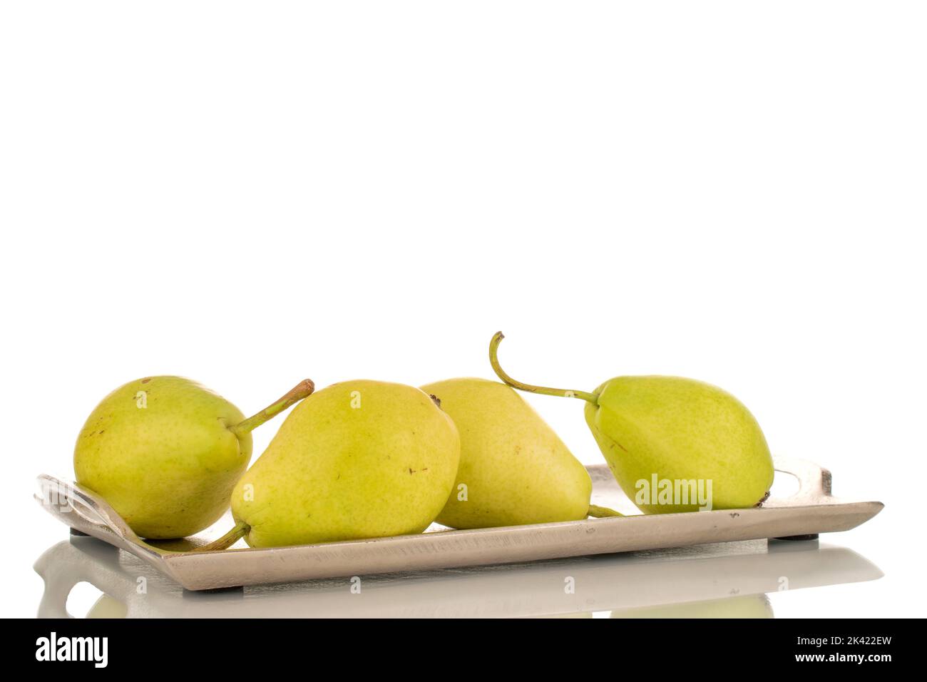 Several ripe green pears on a metal tray, macro, isolated on white ...
