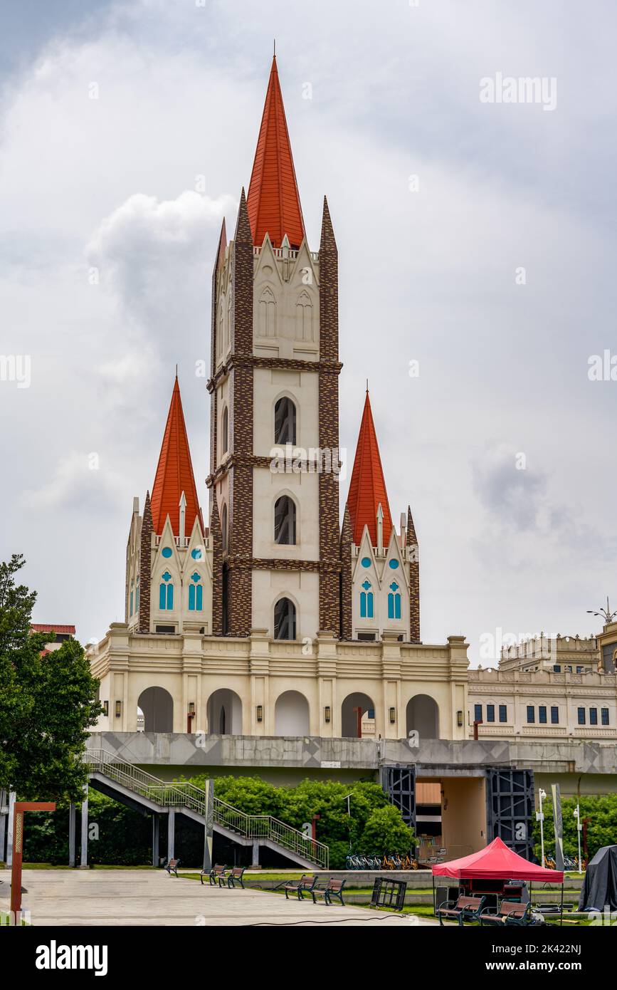 A red gothic steeple church building Stock Photo - Alamy